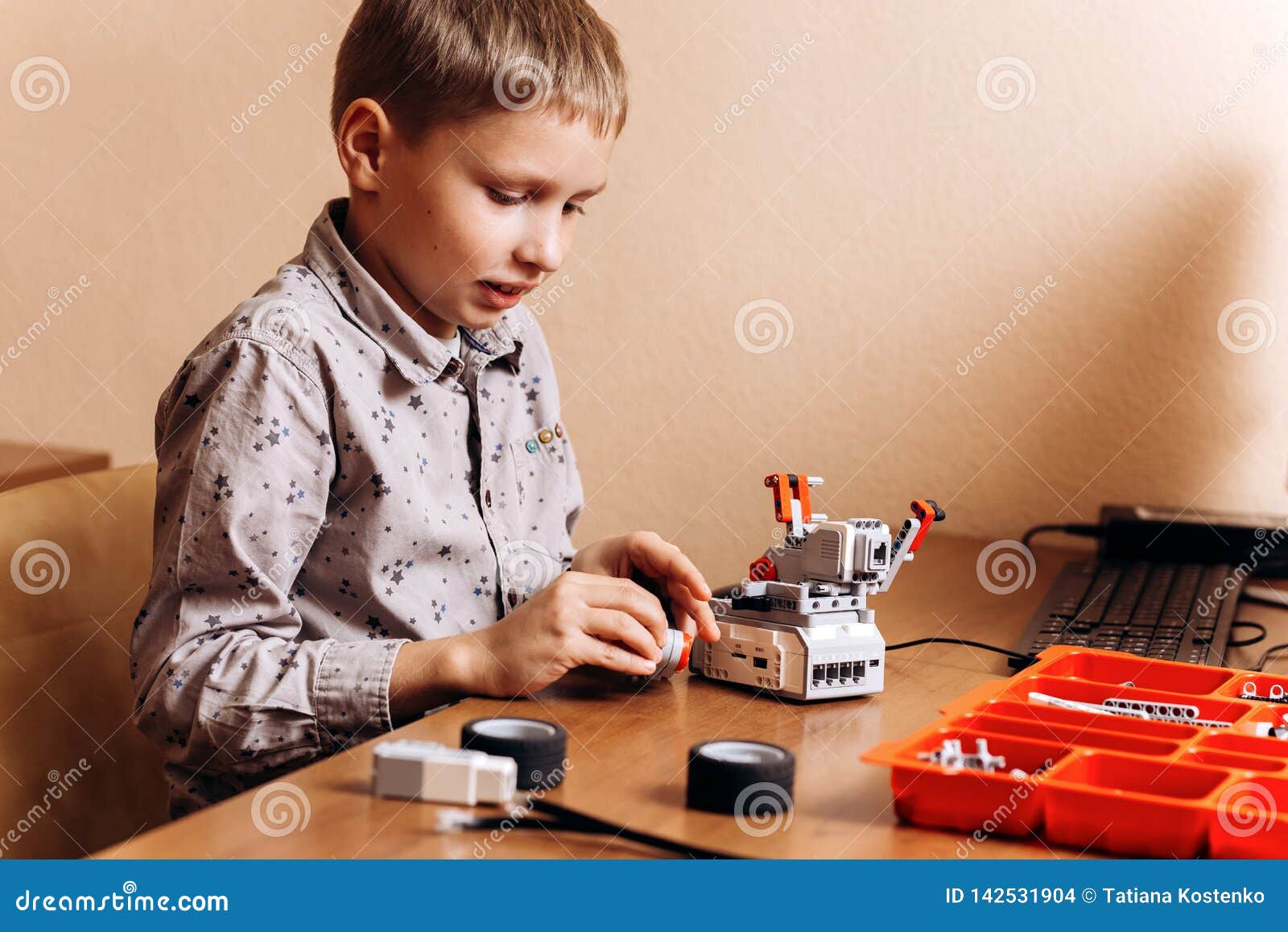 Diligent Boy Dressed in Gray Shirt Makes a Robot from the Robotic ...