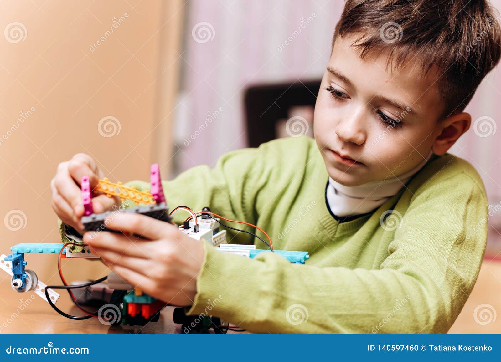 Diligent Boy Dressed in Green Sweater Sits at the Desk with Computer ...