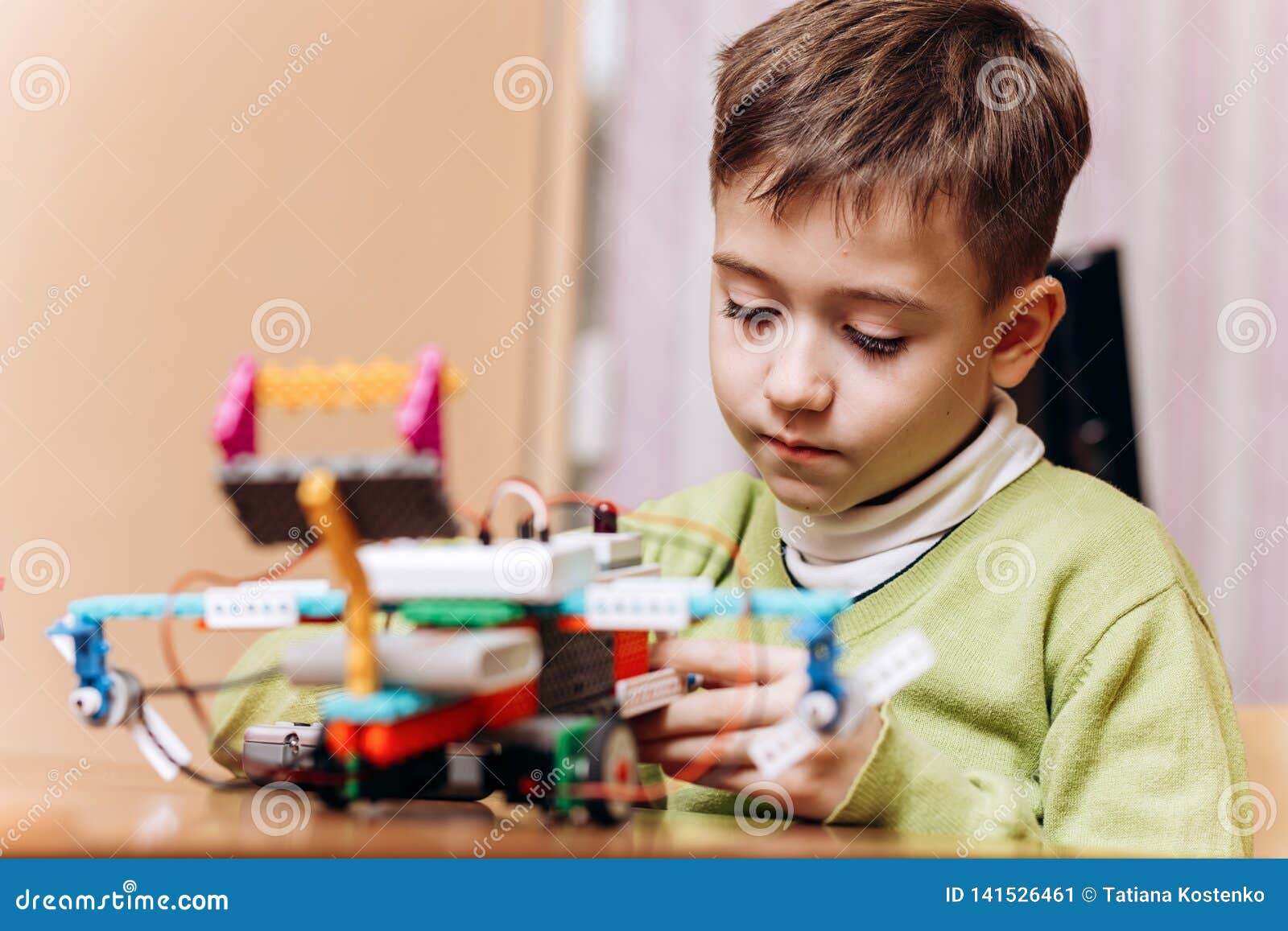 Diligent Boy Dressed in Green Sweater Sits at the Desk with Computer ...