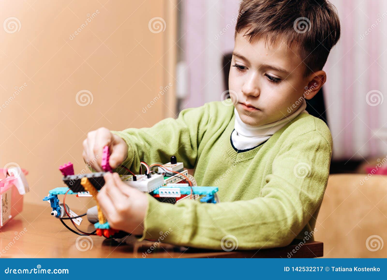 Diligent Boy Dressed in Green Sweater Sits at the Desk with Computer ...