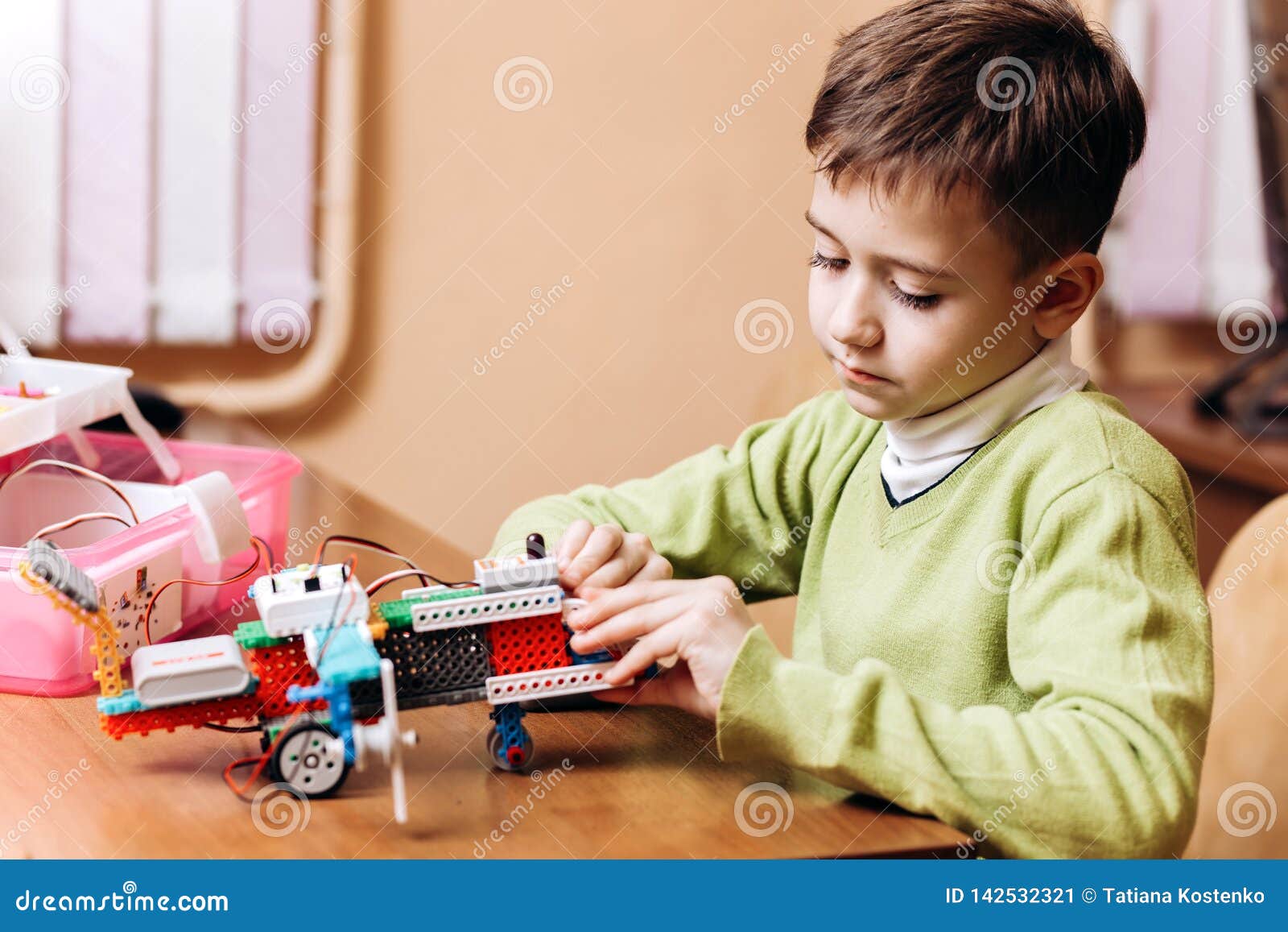 Diligent Boy Dressed in Green Sweater Sits at the Desk with Computer ...
