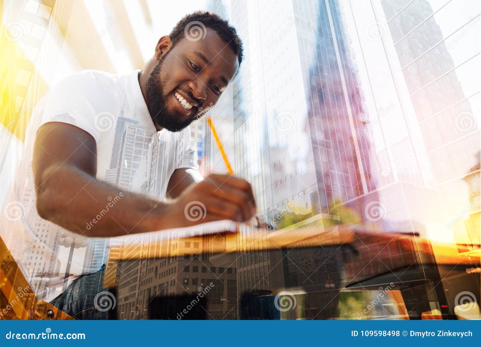 Diligent Cheerful Student Looking Responsible while Making Notes Stock ...