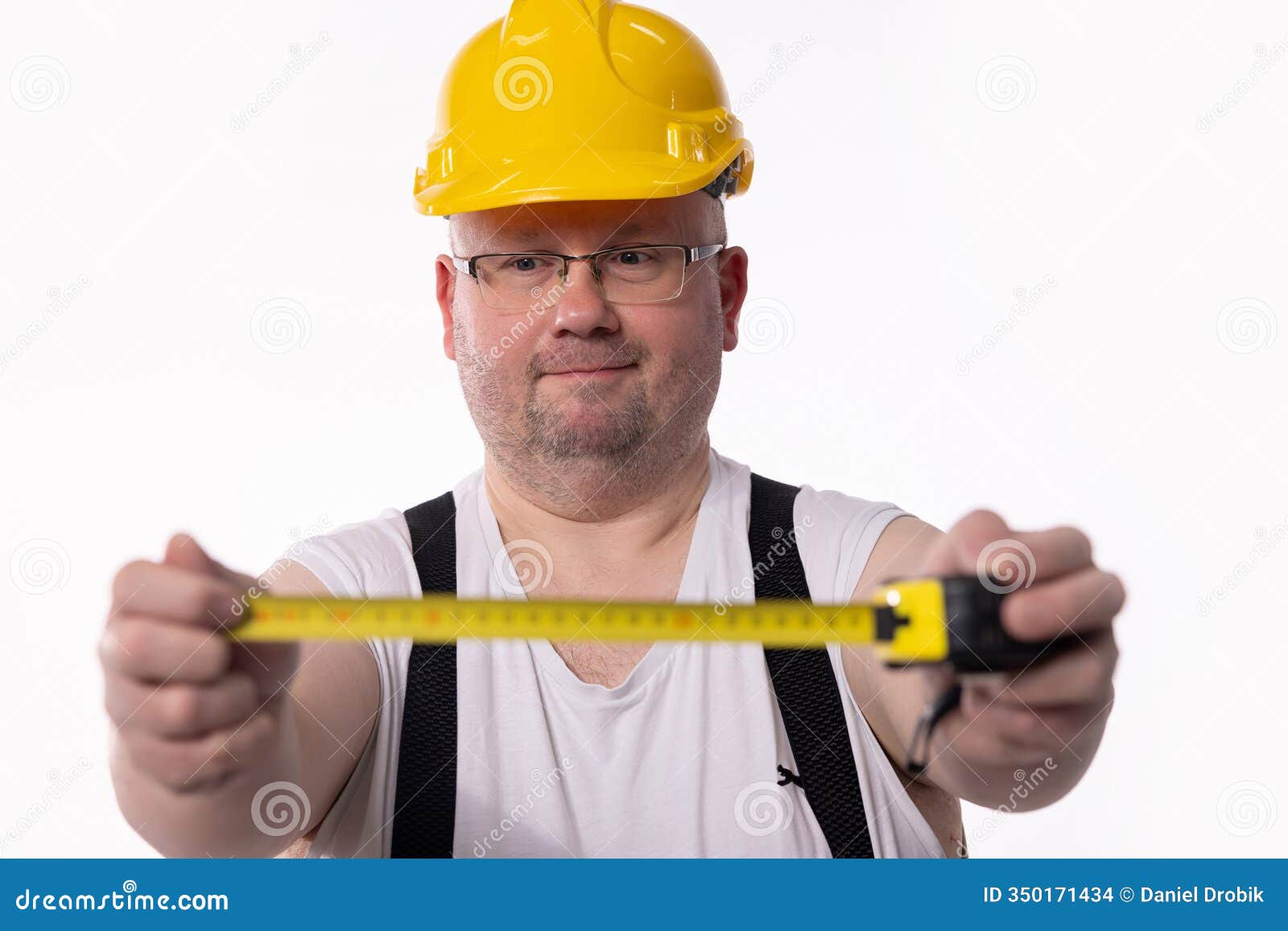 A Diligent Construction Worker is Measuring Something with a Tape ...