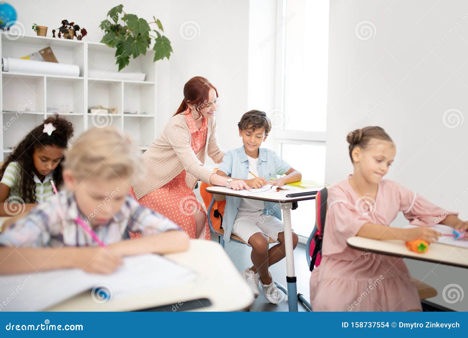 Diligent Pupils Listening To Teacher and Writing Down Words Stock Photo ...