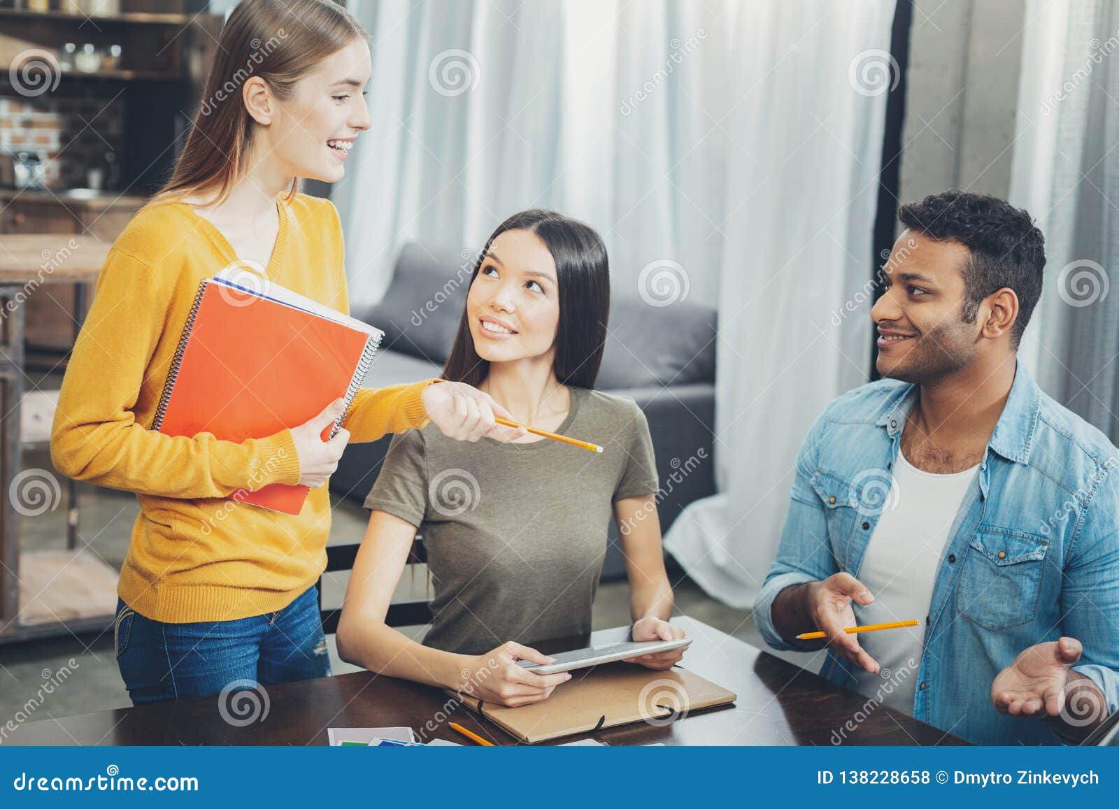 Enthusiastic Three Students Introducing Ideas Stock Photo - Image of ...