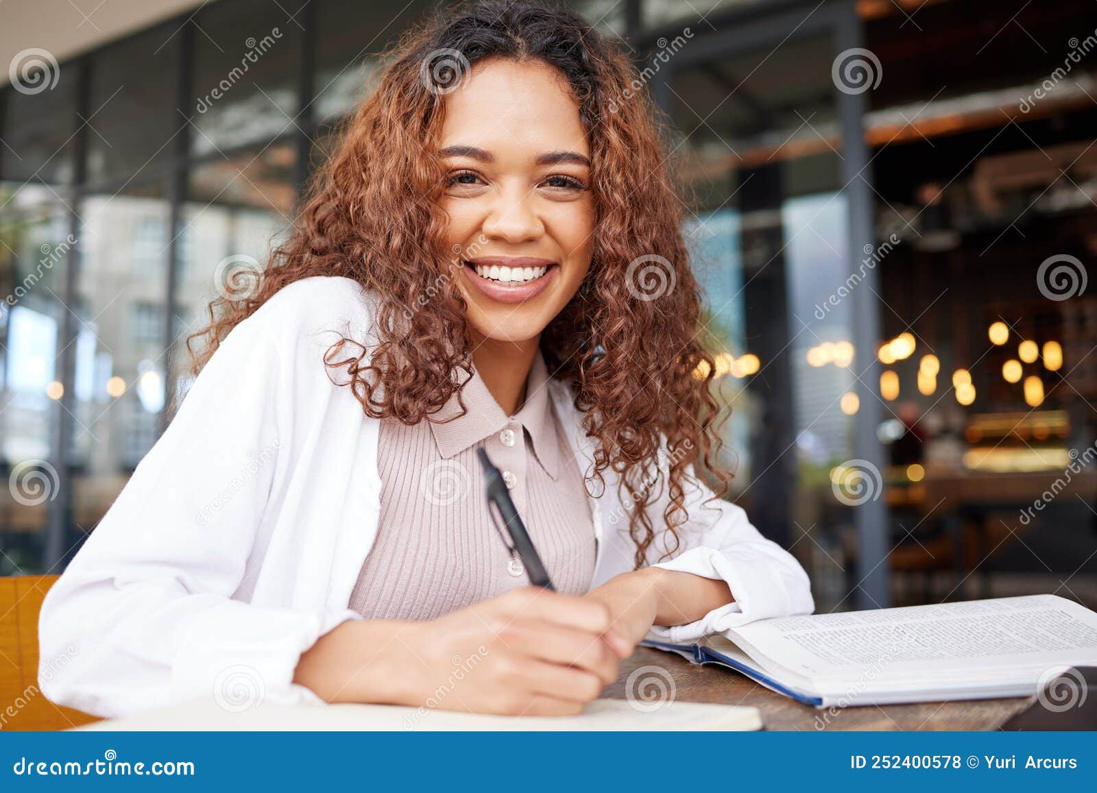 A Diligent Student. a Young Businesswoman Writing in a Notebook while ...