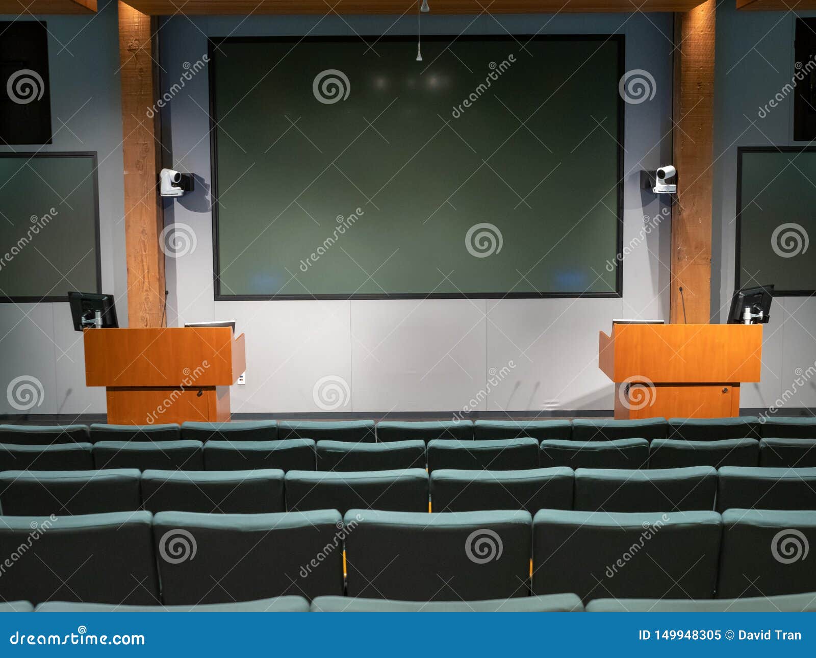 Dimly Lit Office Auditorium with Double Podiums and Multi Projector ...