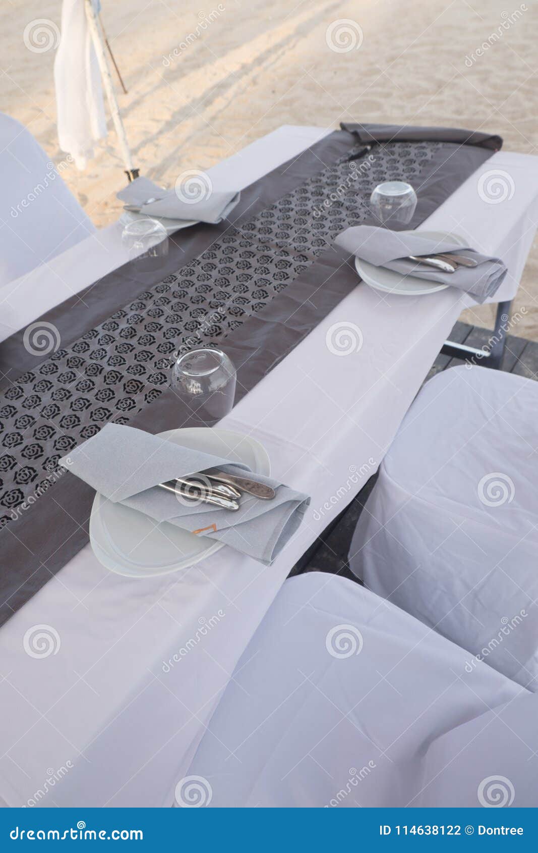 Dining table on the beach stock photo. Image of restaurant - 114638122
