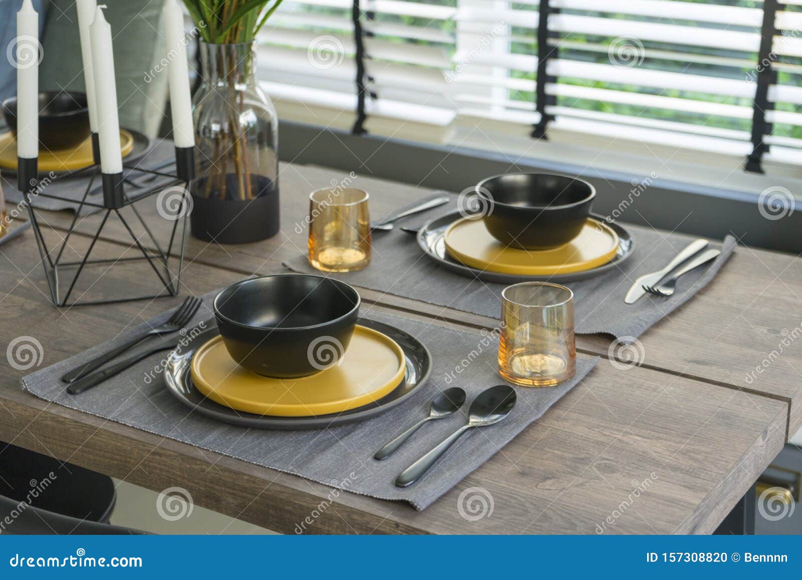 Dining Table with Black and Yellow Plate Setting in Home. Stock Photo ...