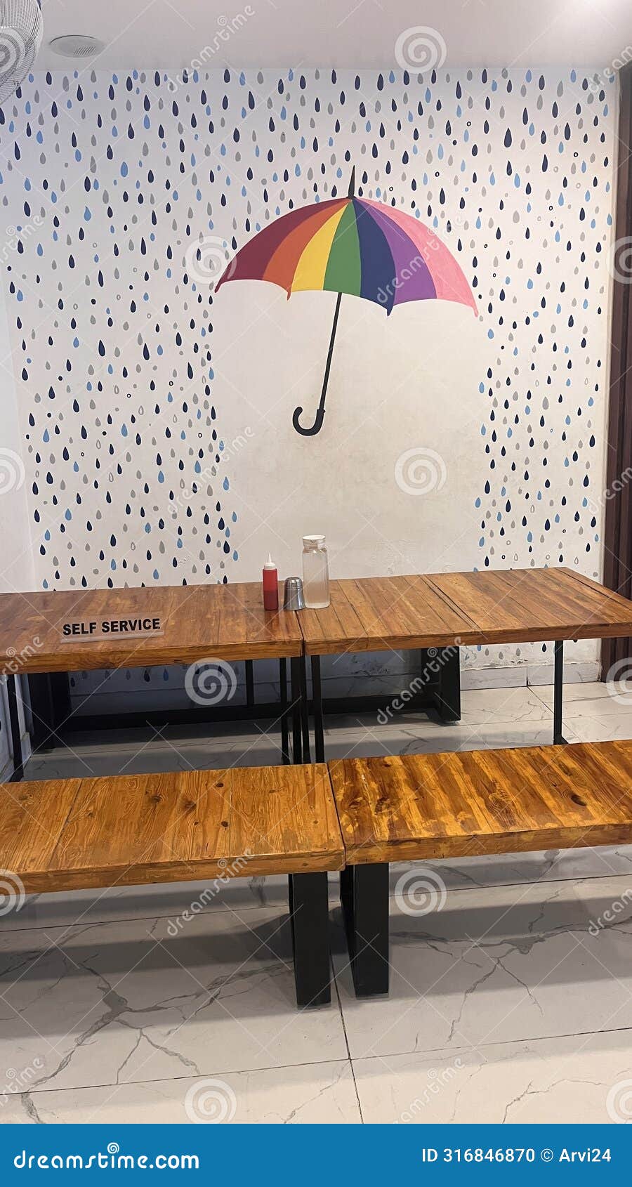 A Dining Table Facing the White Designed Wall Stock Photo - Image of ...