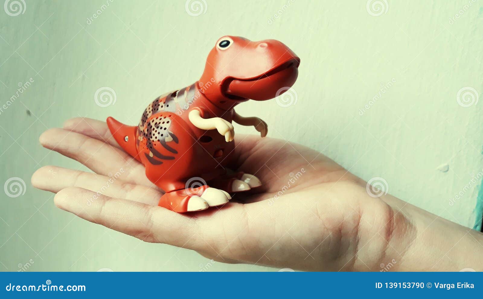 Dinosaur in hand stock photo. Image of dinosaur, object - 139153790