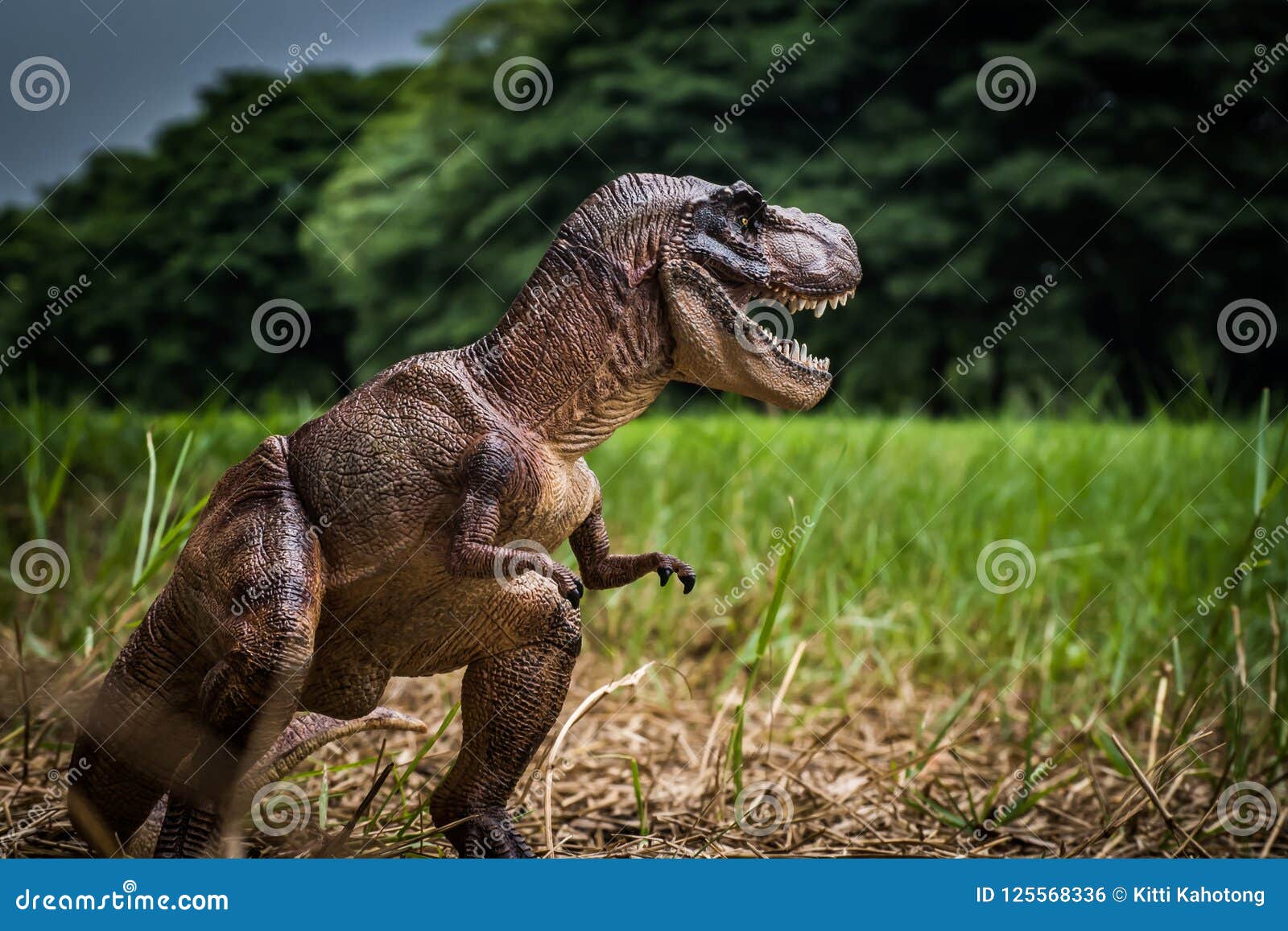 Dinosaur , T-rex with Tree Branches Against on the Nature. Stock Photo ...