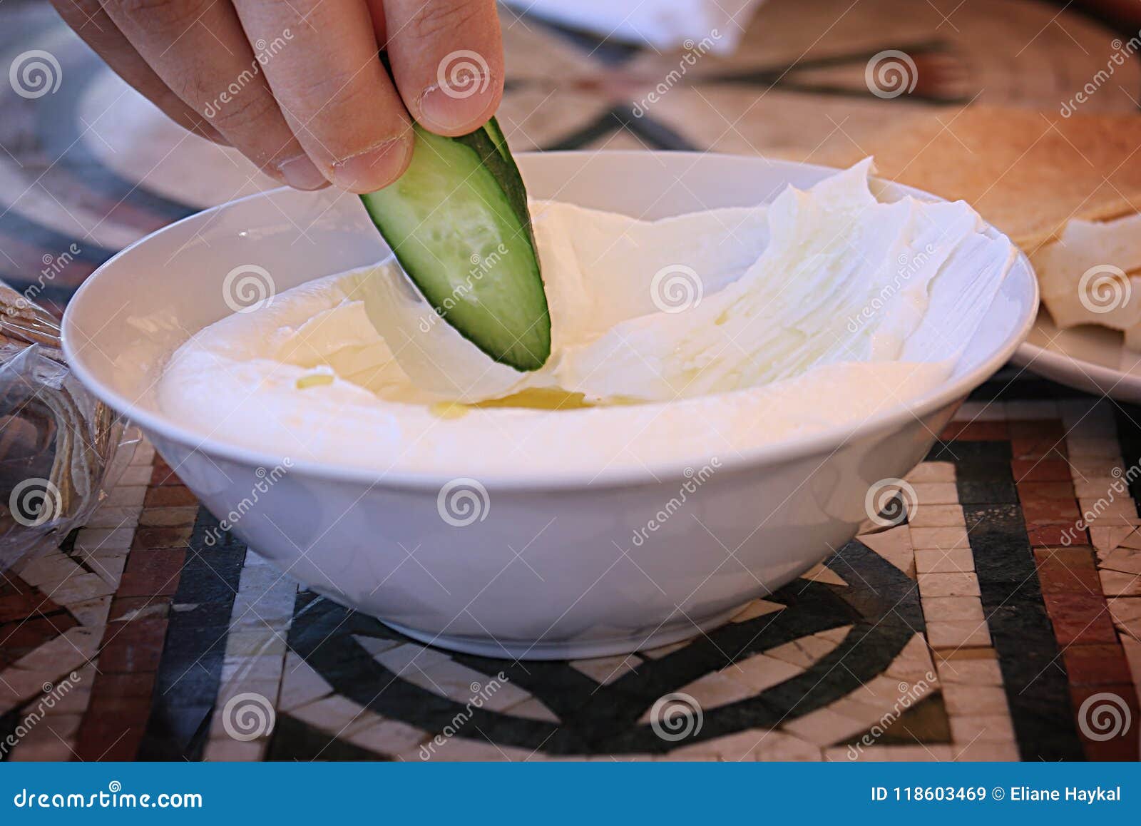 Dipping Cucumber in Labneh stock image. Image of cucumber - 118603469