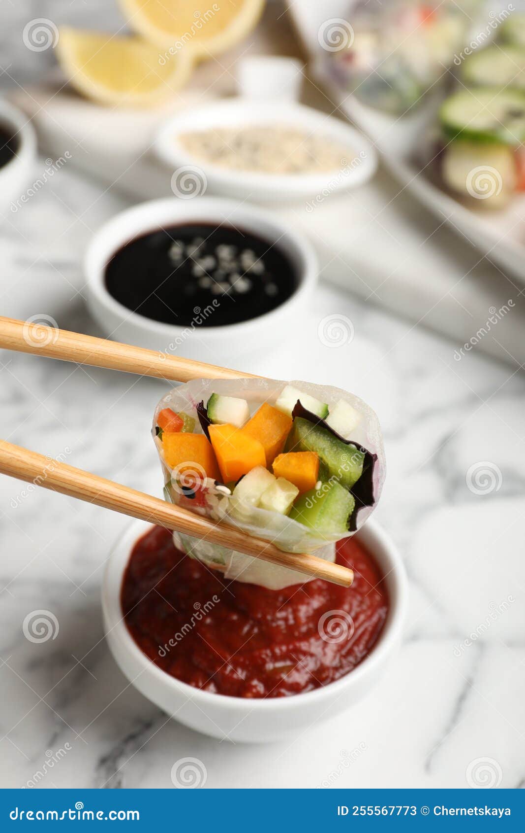 Dipping Delicious Roll Wrapped in Rice Paper into Sauce at White Marble ...