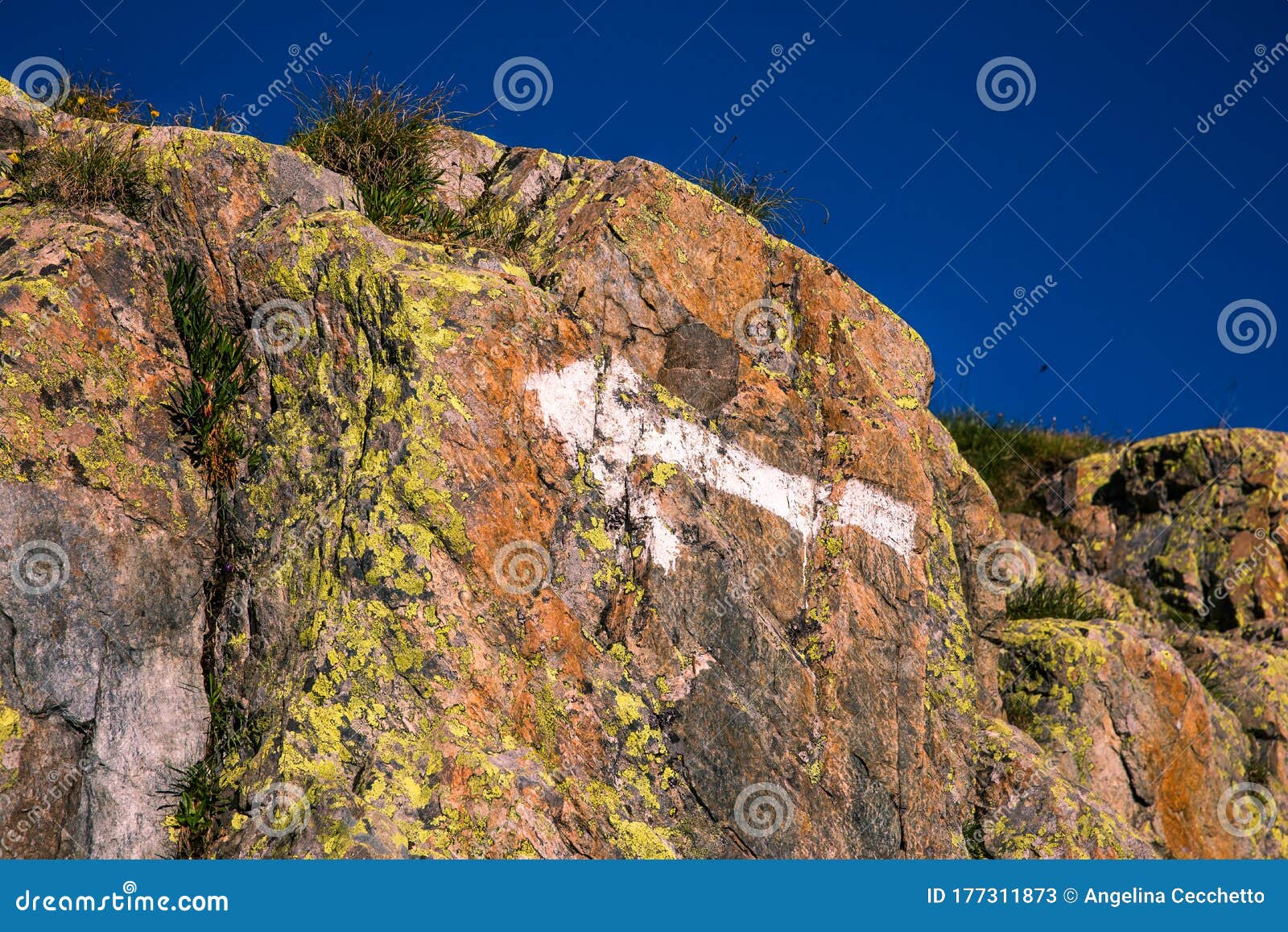 Direction Arrow Sign Hand Painted on Rocks with Deep Blue Sky Stock ...