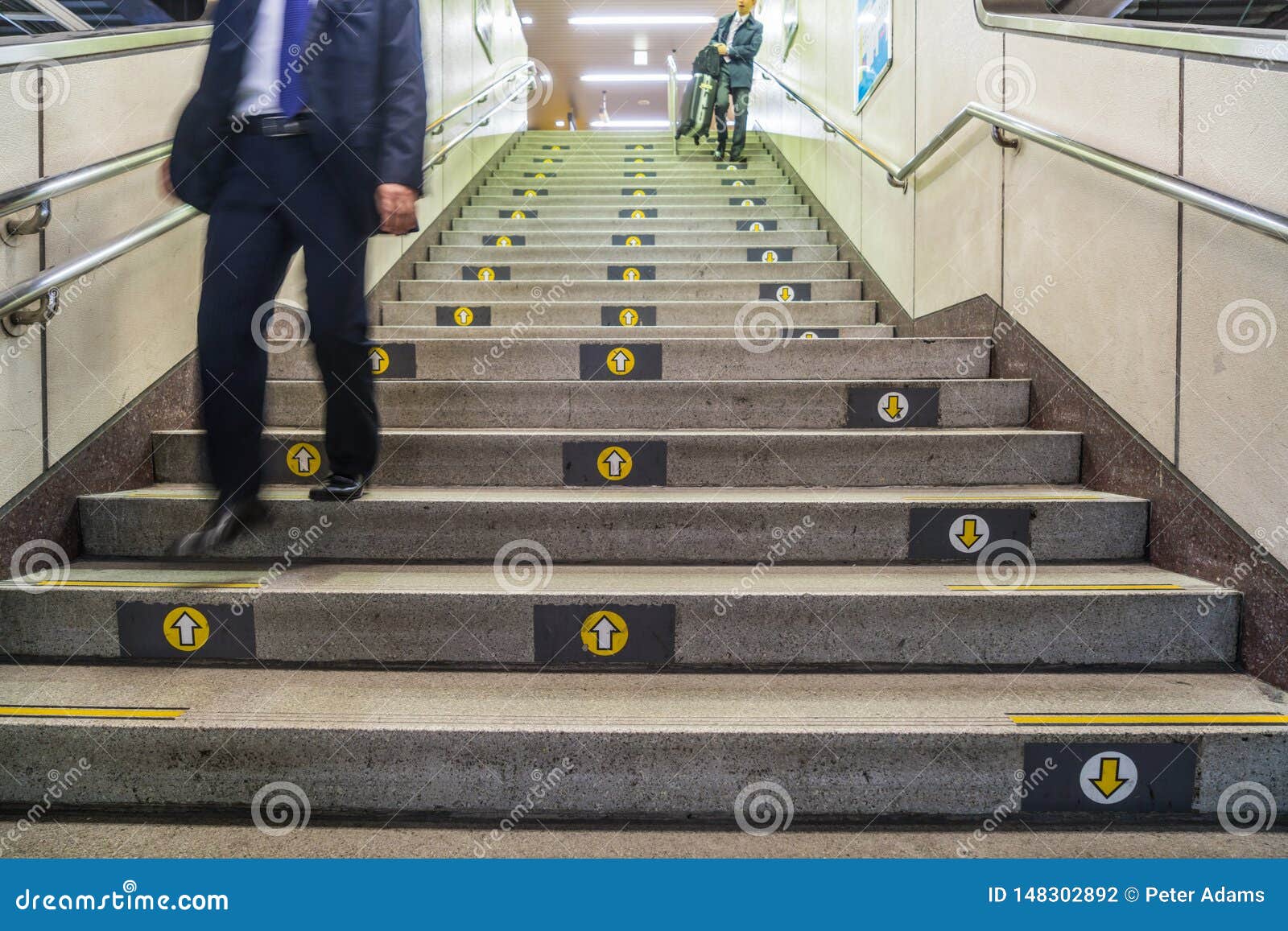 Direction Arrows on Steps on Tokyo Subway with Commuters Editorial ...