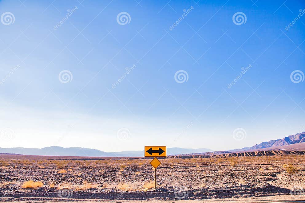 Direction Sign in the Desert Under a Blue Sky. Concept of Uncertain ...