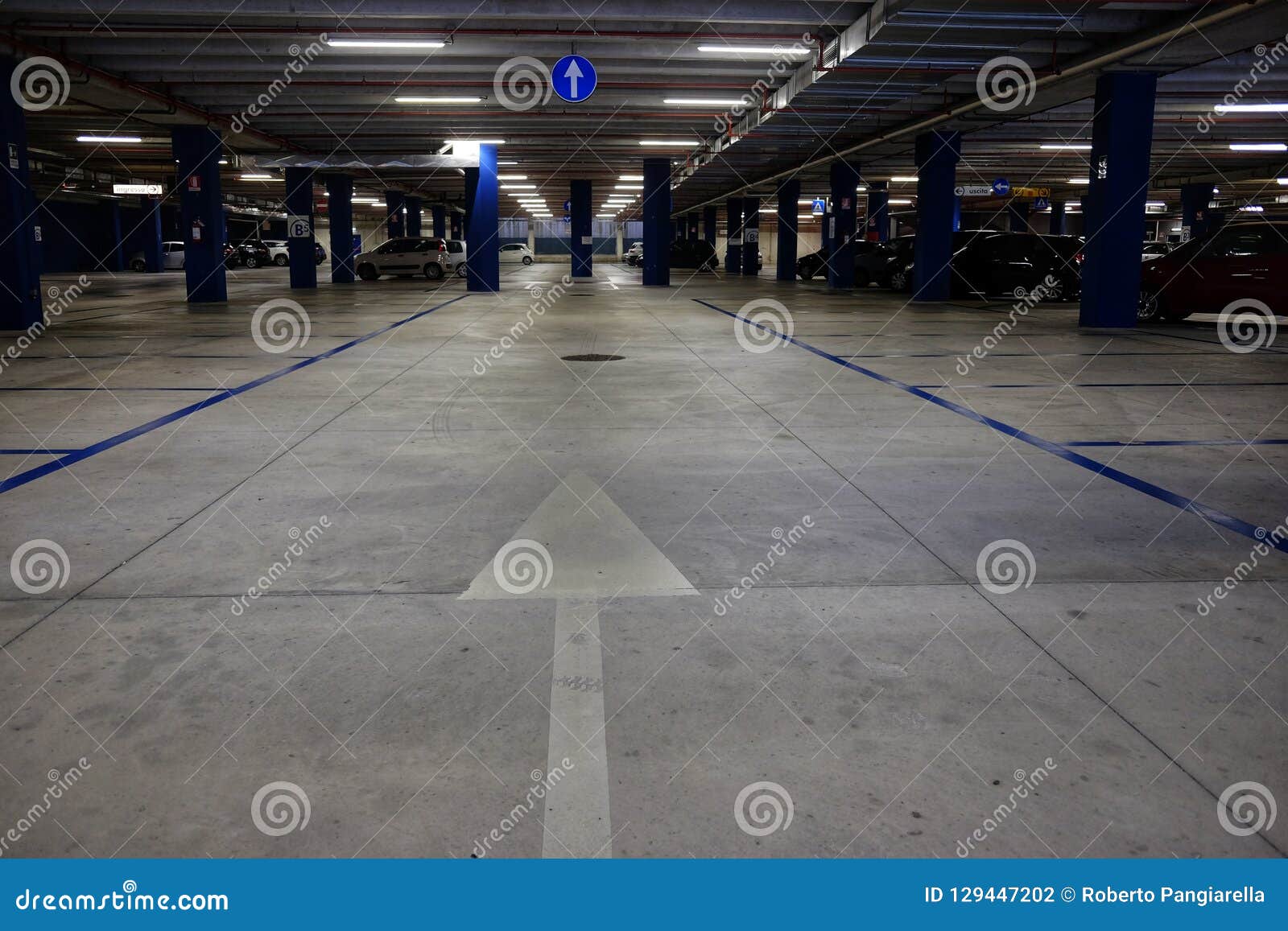 Directional Arrows in the Underground Parking Stock Photo - Image of ...
