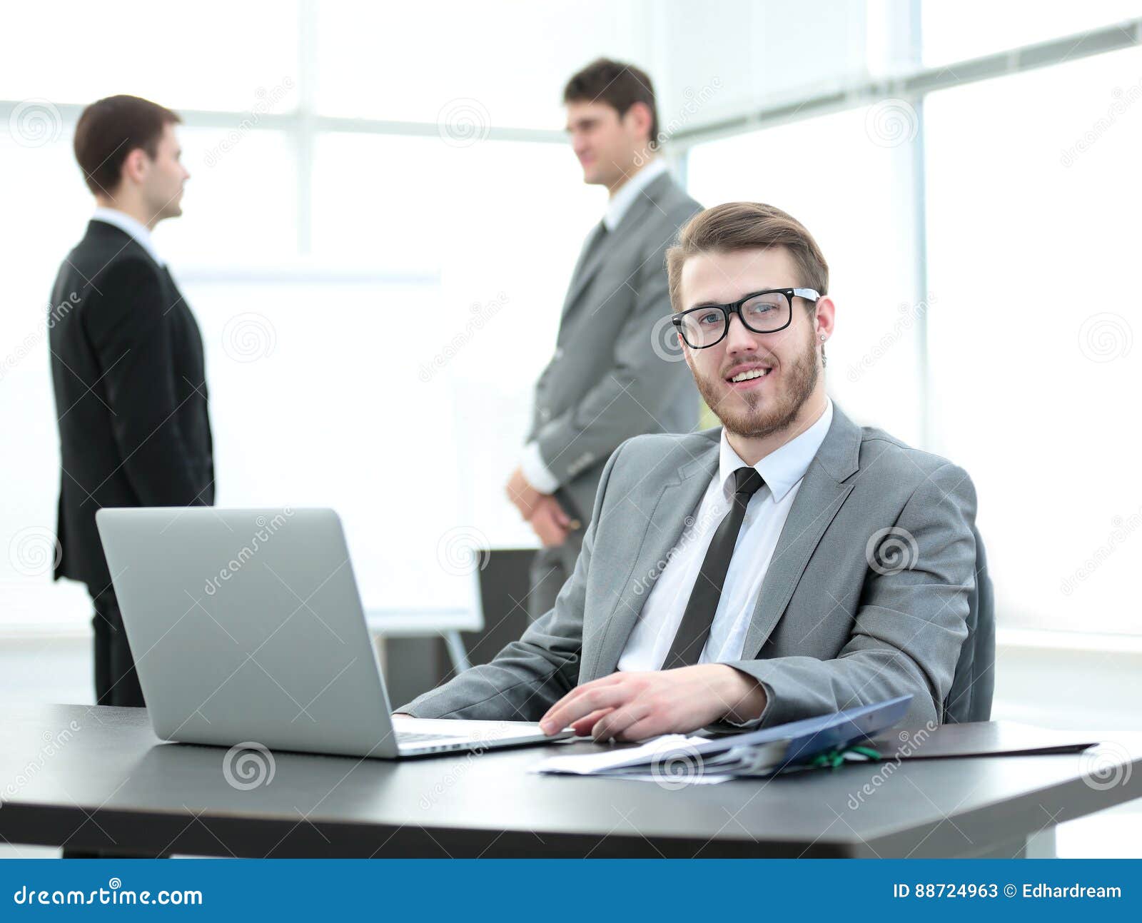 Director is Sitting at the Table with an Open Laptop and Papers. Stock ...