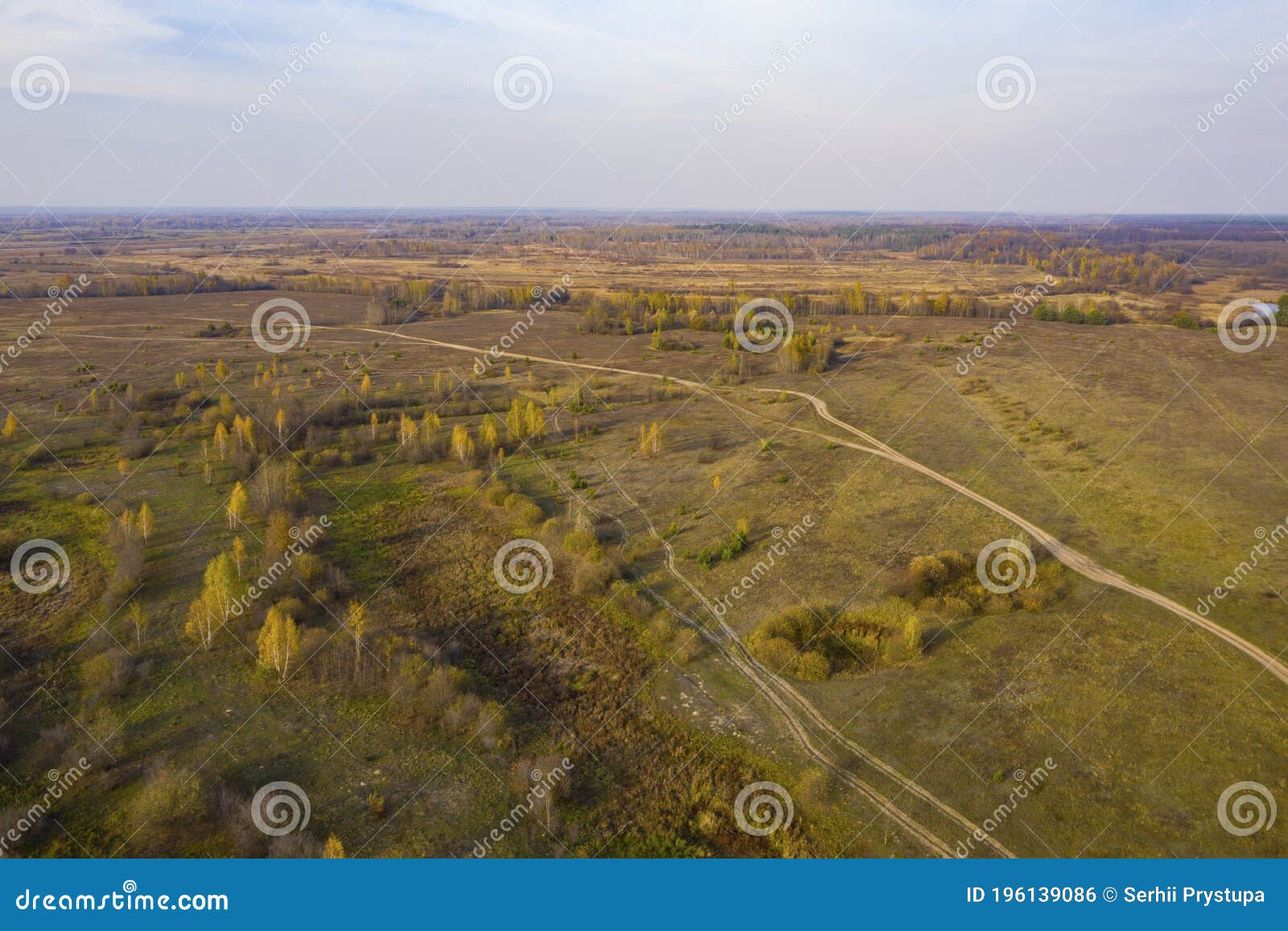 A Dirt Road Runs through a Field. Stock Photo - Image of landscape ...