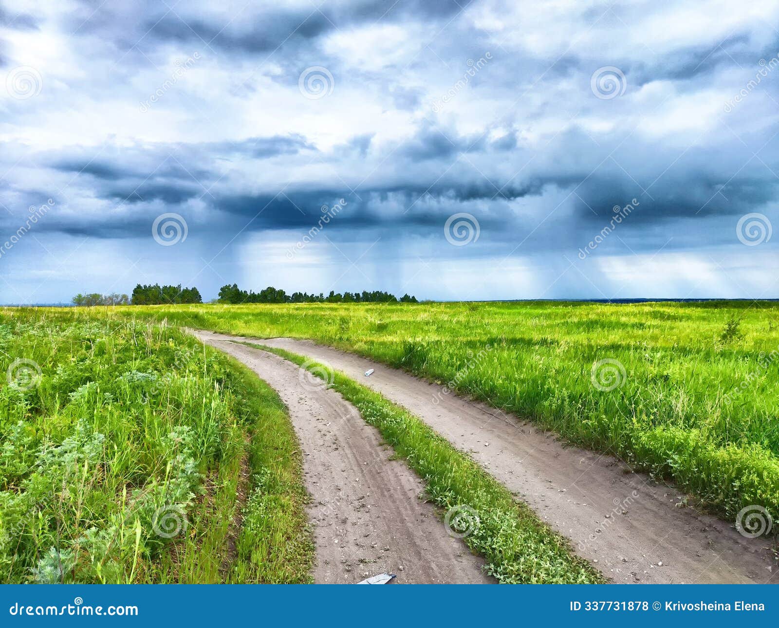 A Dirt Road Winds through a Grassy Field, with a Storm Brewing in the ...