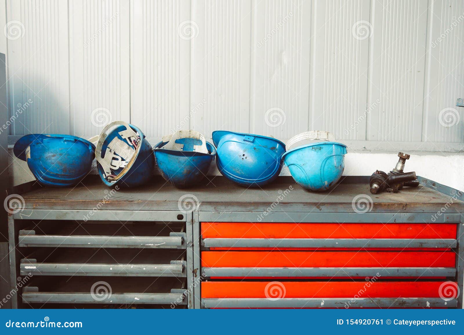 Dirty Blue Worker Helmets on Top of an Old, Rusty and Dirty Workbench ...