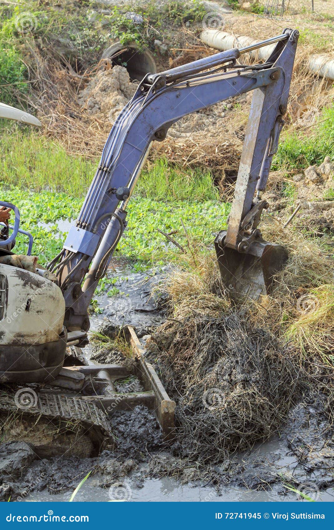 Dirty Bucket of Backhoe Digging Mud and Weed in a Canal. Stock Image ...