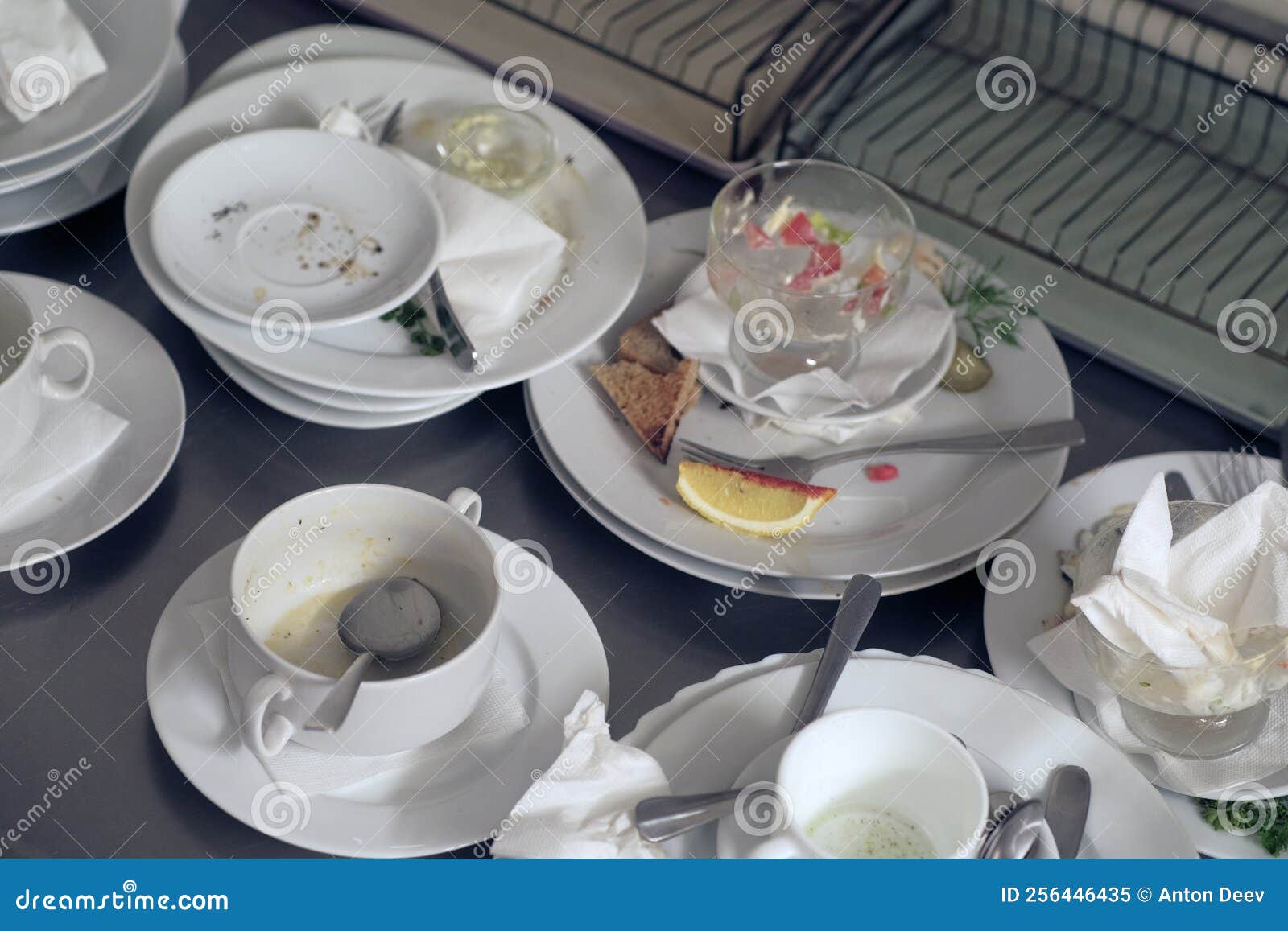 Dirty Cups and Plates with Leftovers and Silverware Placed on Metal ...
