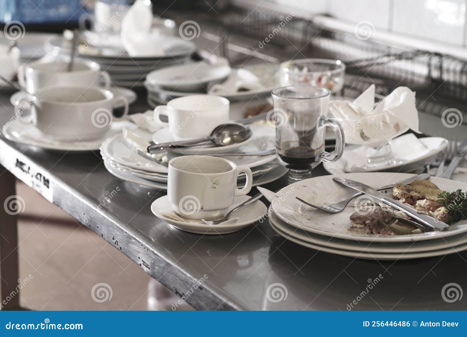 Dirty Cups and Plates with Leftovers and Silverware Placed on Metal ...