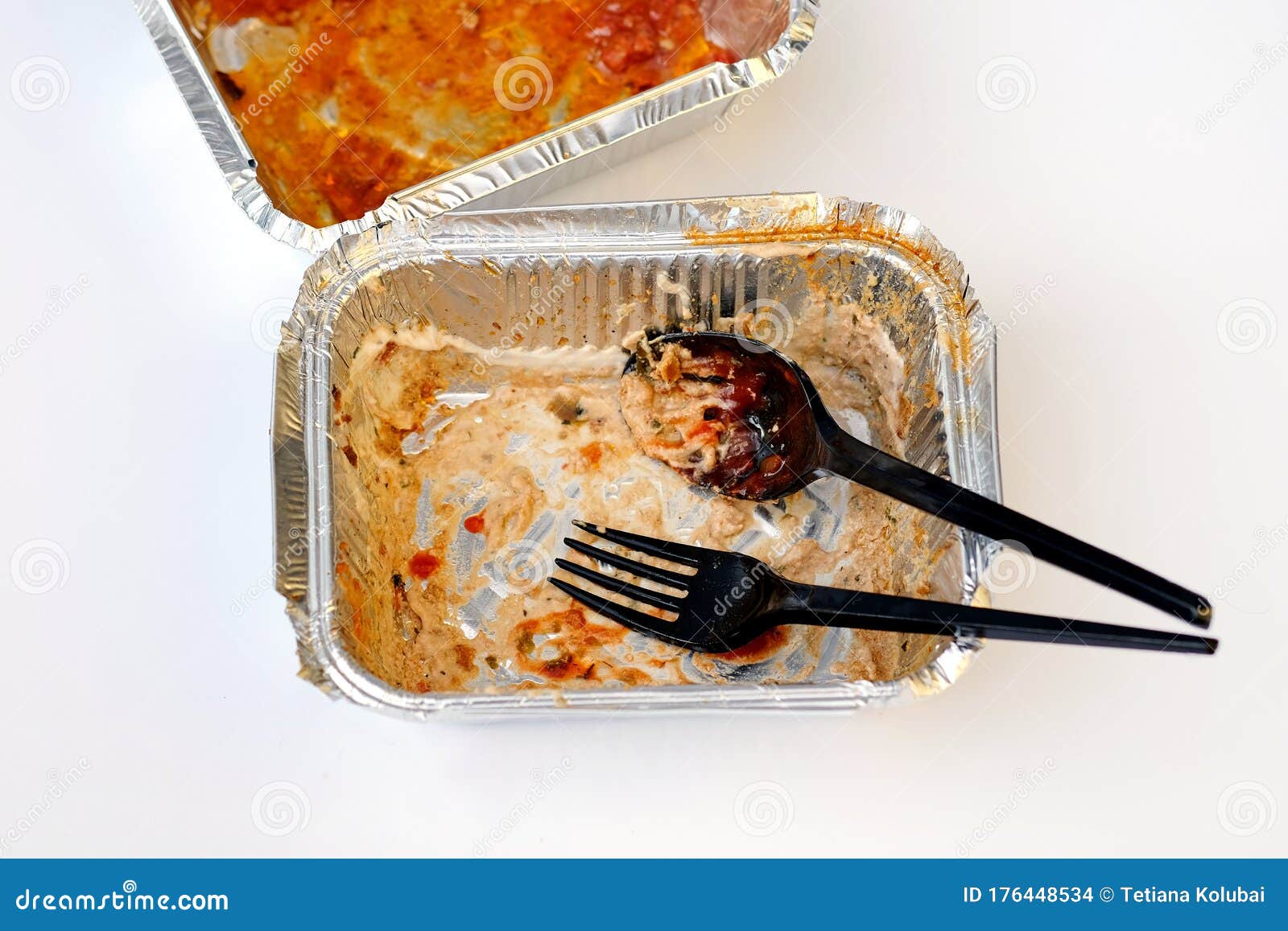 Dirty Empty Aluminum Container with Black Plastic Spoon and Fork Top ...