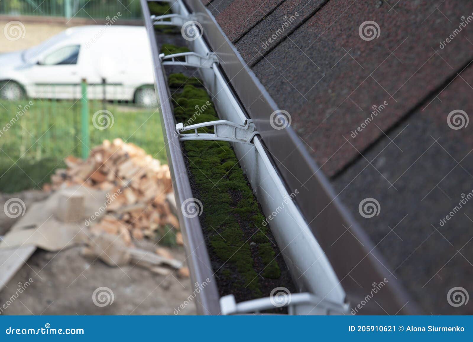 Dirty Gutter System Clogged with Dirt and Moss. Gutter System Clogged ...