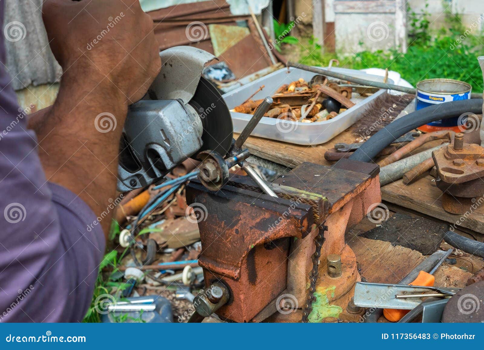 Independent Tool Making Using a Vise and Angle Grinder, Hands of a ...
