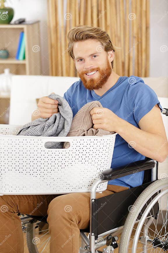 Disable man doing laundry stock photo. Image of confidence - 308149836