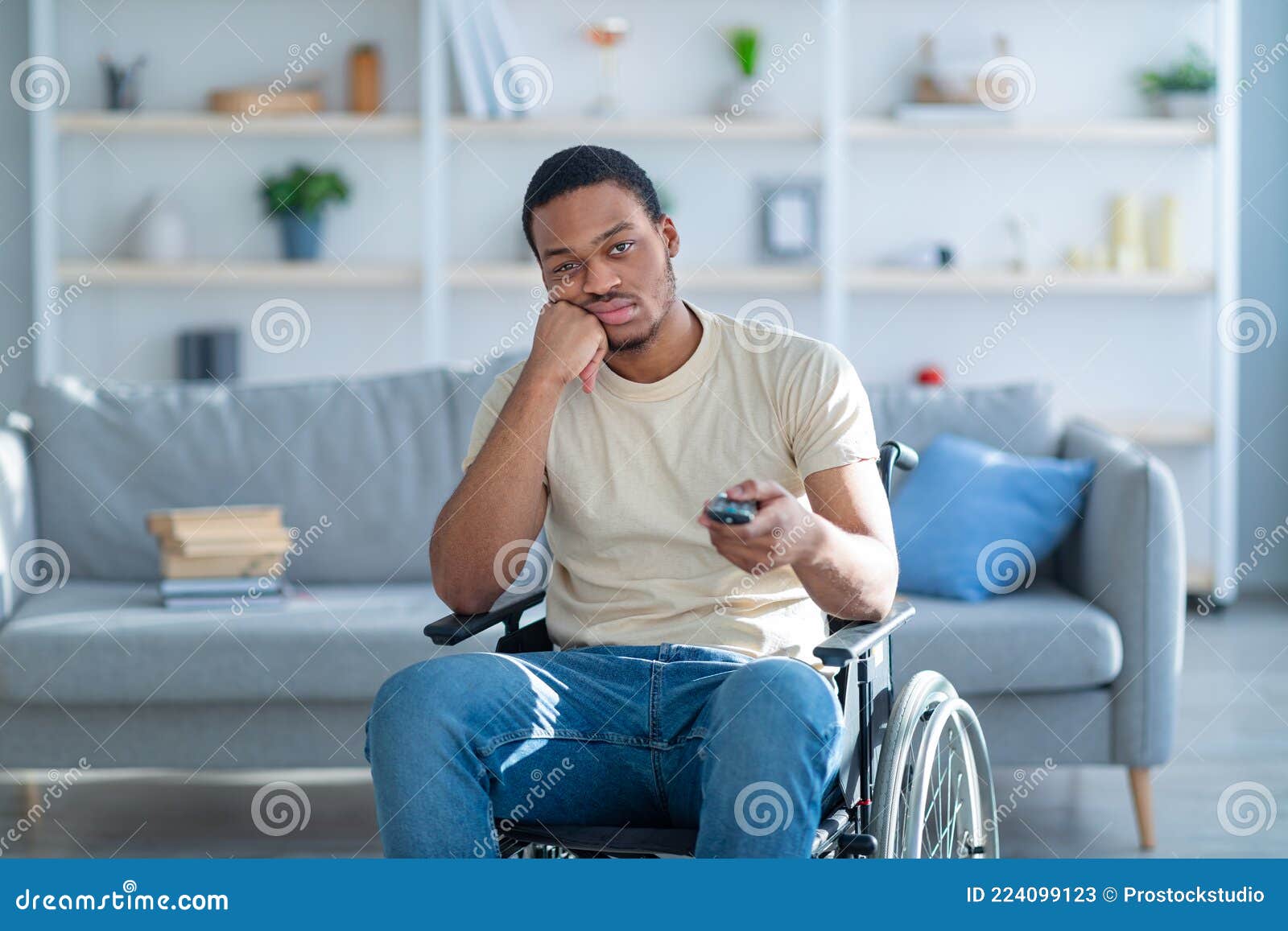 Disabled Black Man in Wheelchair Using Remote Control, Watching Dull ...