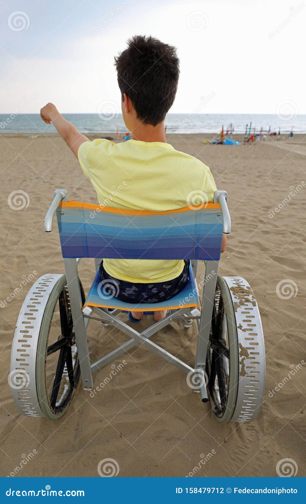 Disabled Boy on a Wheelchair Points the Sea Stock Photo - Image of ...