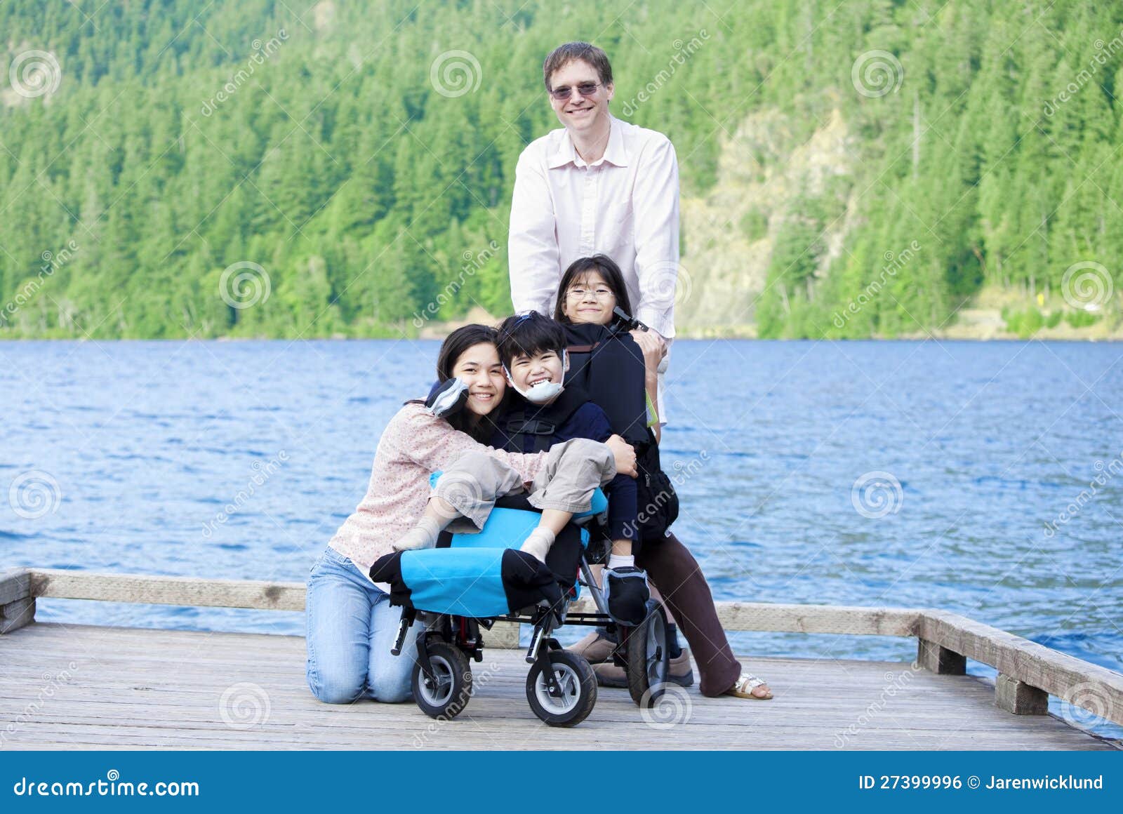 Disabled Boy in Wheelchair Surrounded by Family Stock Photo - Image of ...
