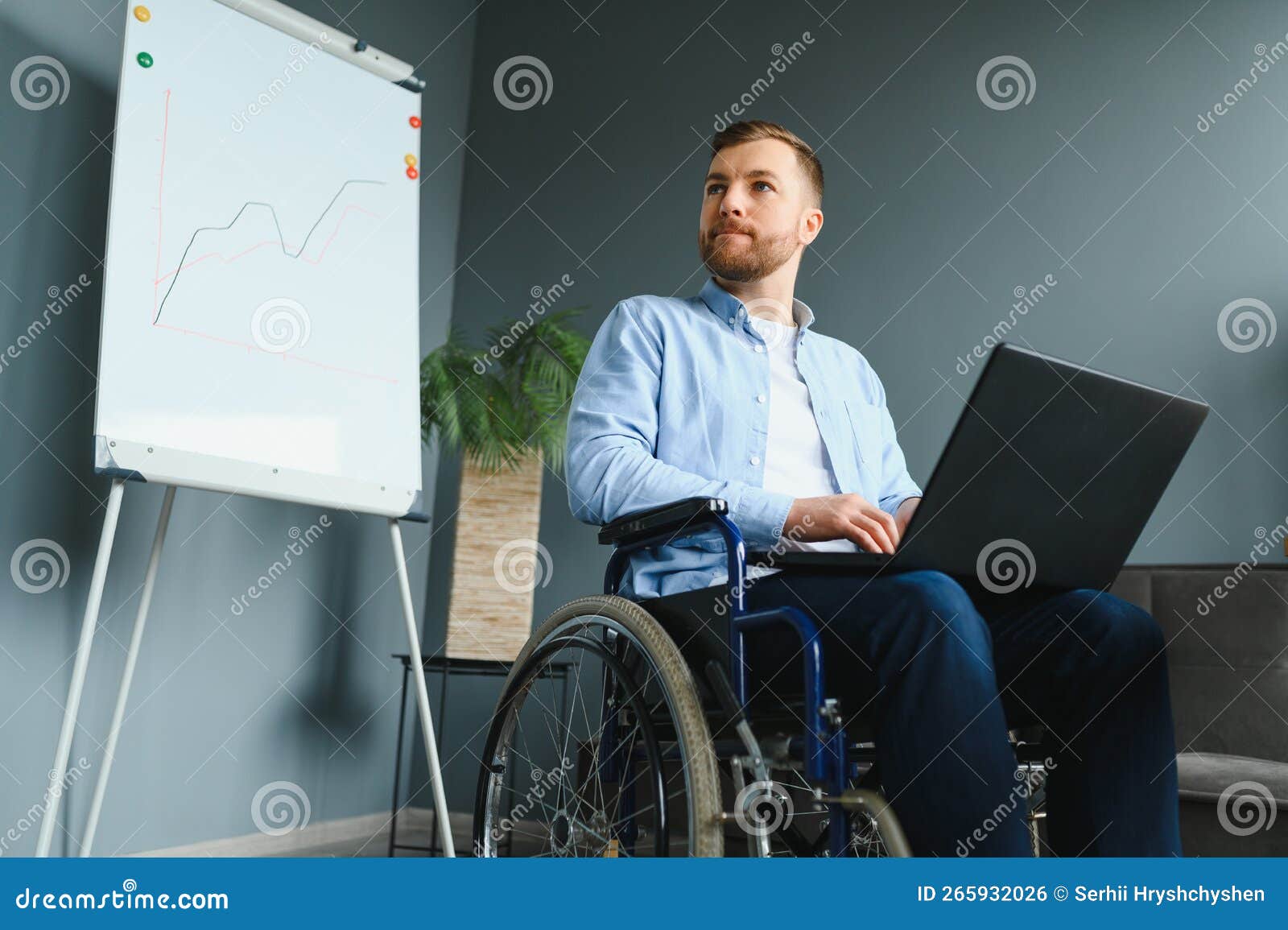 Disabled Businessman Sitting in Wheelchair Using Computer at Workplace ...