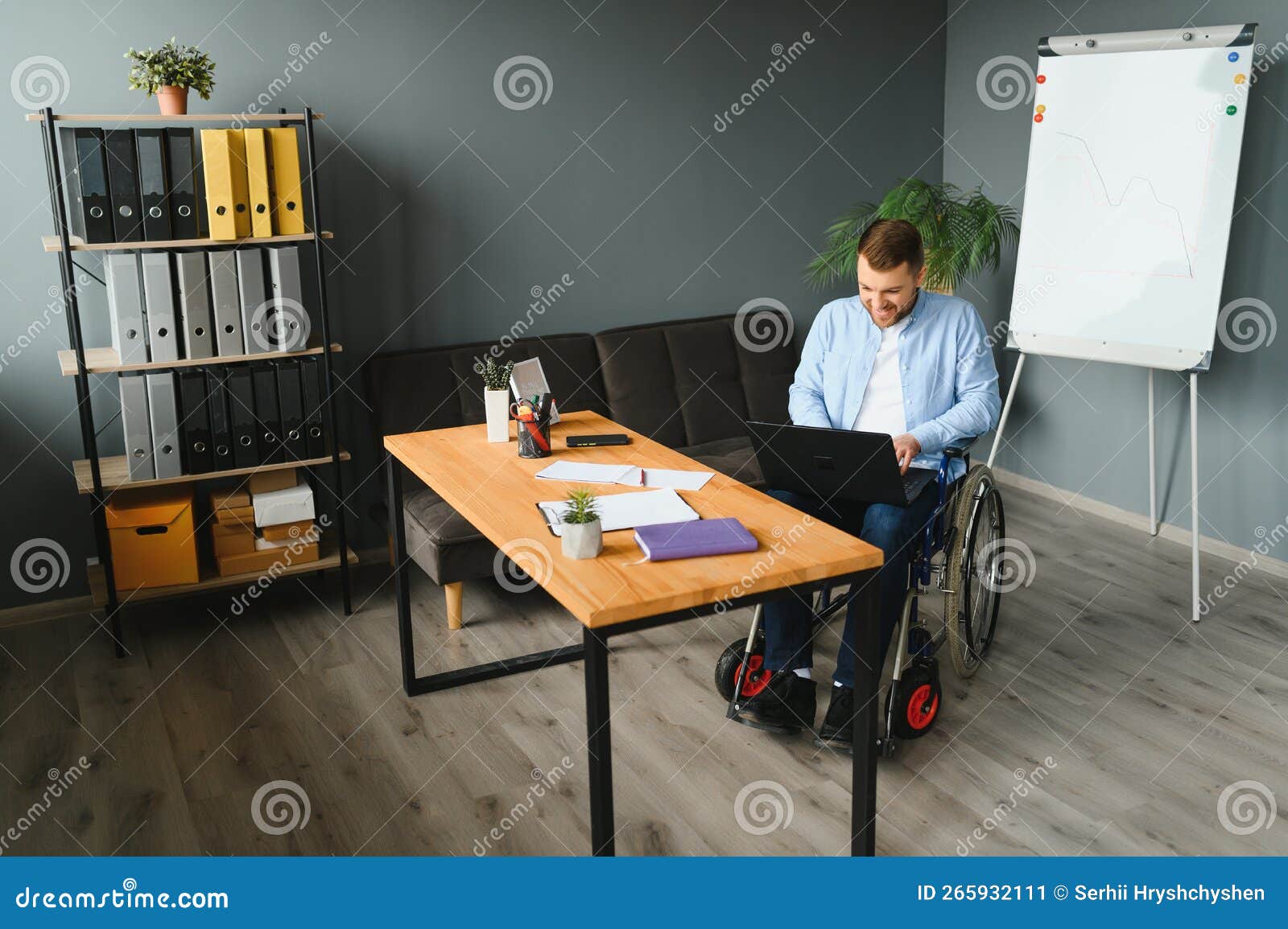 Disabled Businessman Sitting in Wheelchair Using Computer at Workplace ...