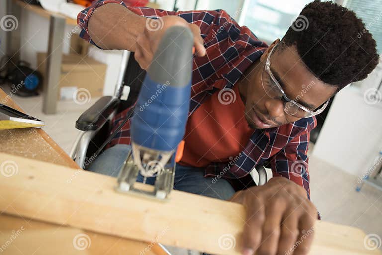 Disabled Carpenter Using Electric Jigsaw Stock Photo - Image of ...
