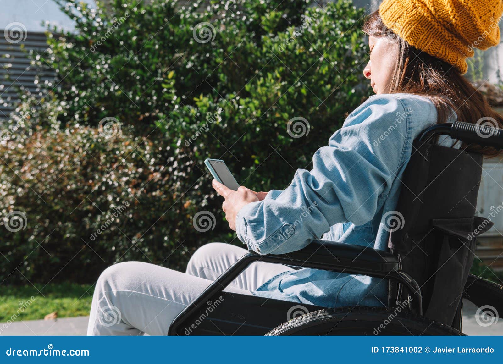 Disabled Girl in a Wheelchair Using Her Mobile Phone Stock Photo ...