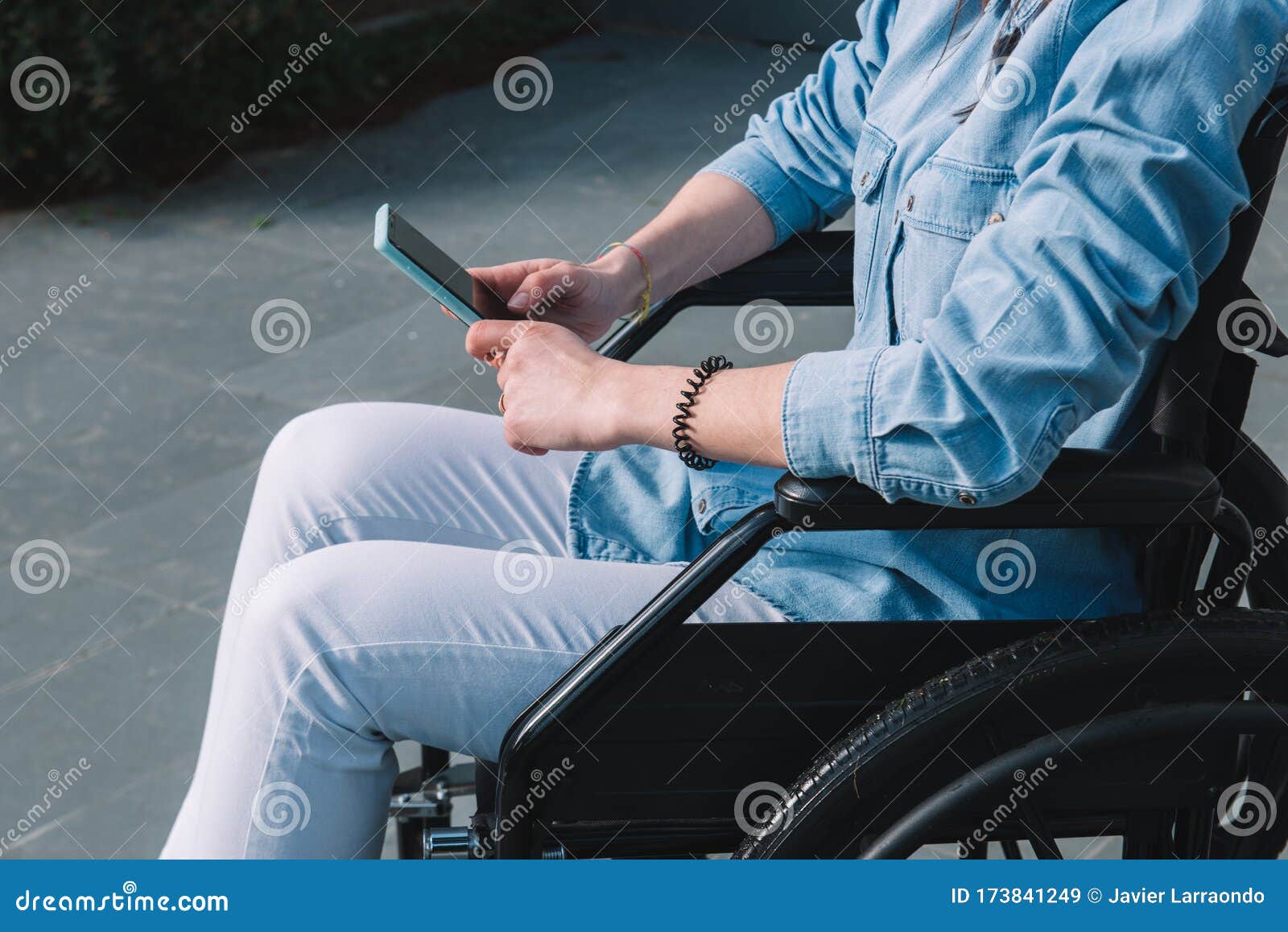 Disabled Girl in a Wheelchair Using Her Mobile Phone Stock Image ...