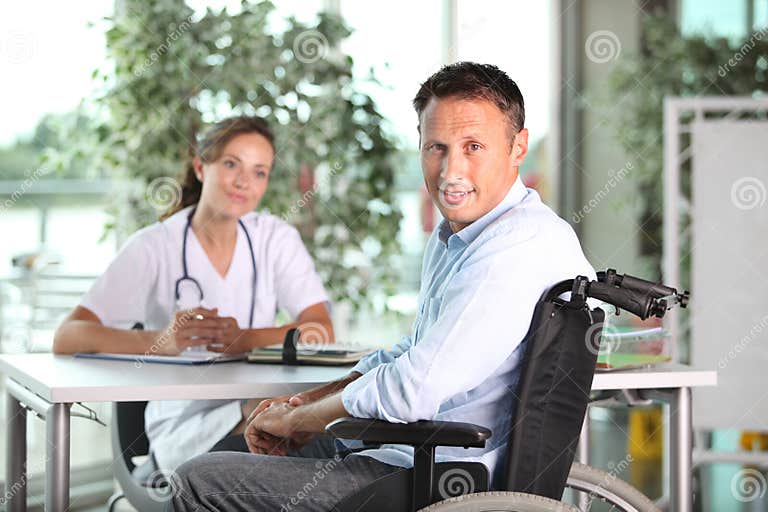 Disabled man with doctor stock photo. Image of indoors - 15869238