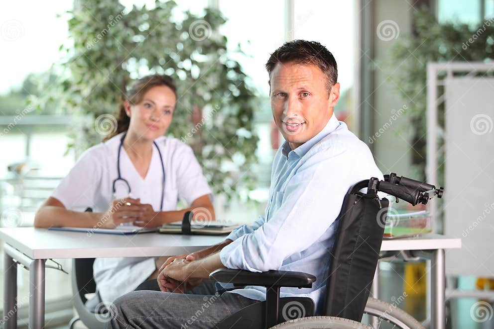 Disabled man with doctor stock photo. Image of indoors - 15869238