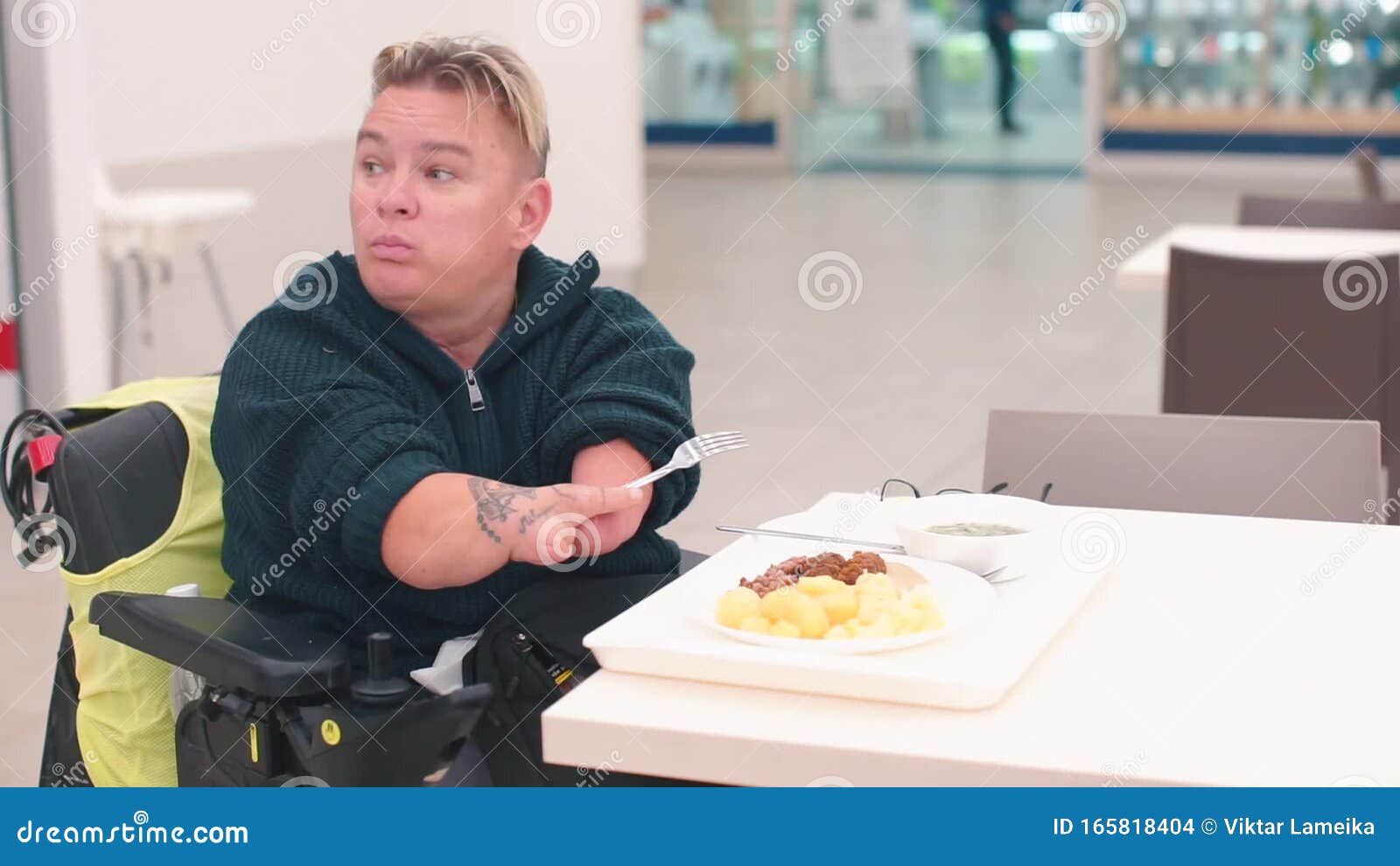 Disabled Man, Office Worker Sitting at a Table in a Restaurant, Eating ...