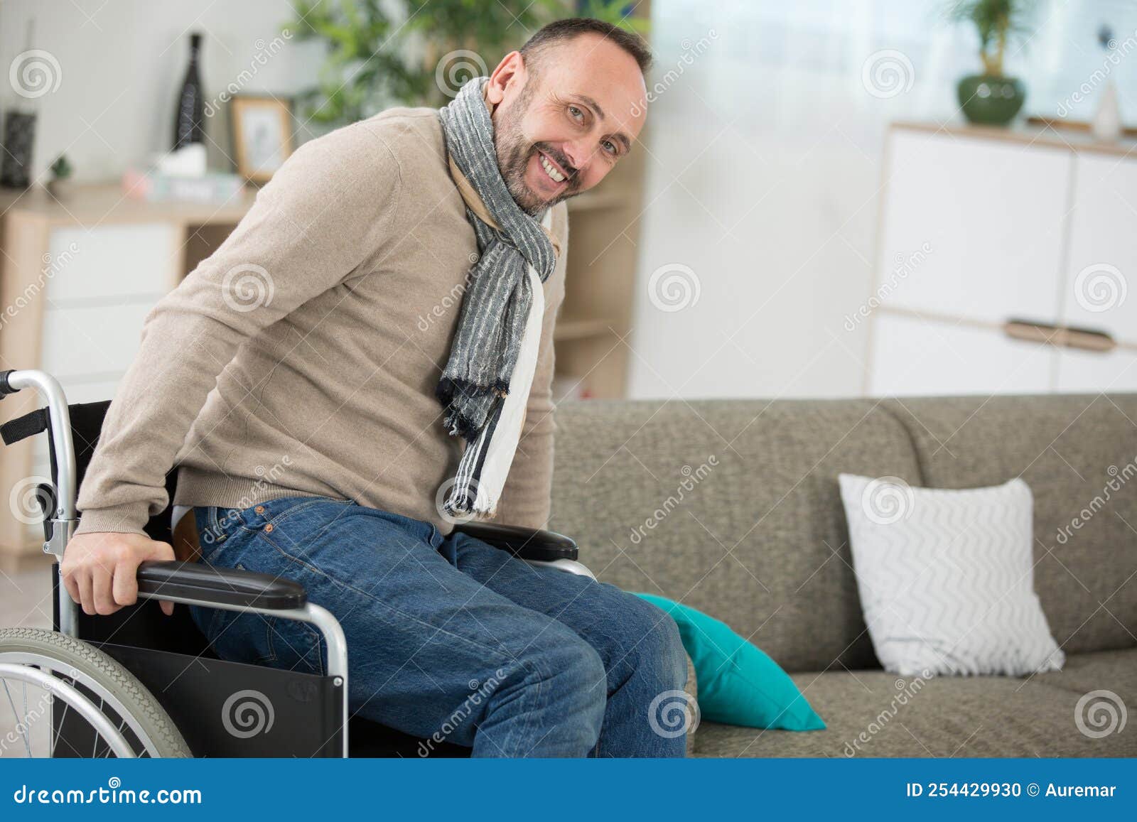 Disabled Man Trying To Sit on Sofa Stock Photo - Image of hands, sofa ...