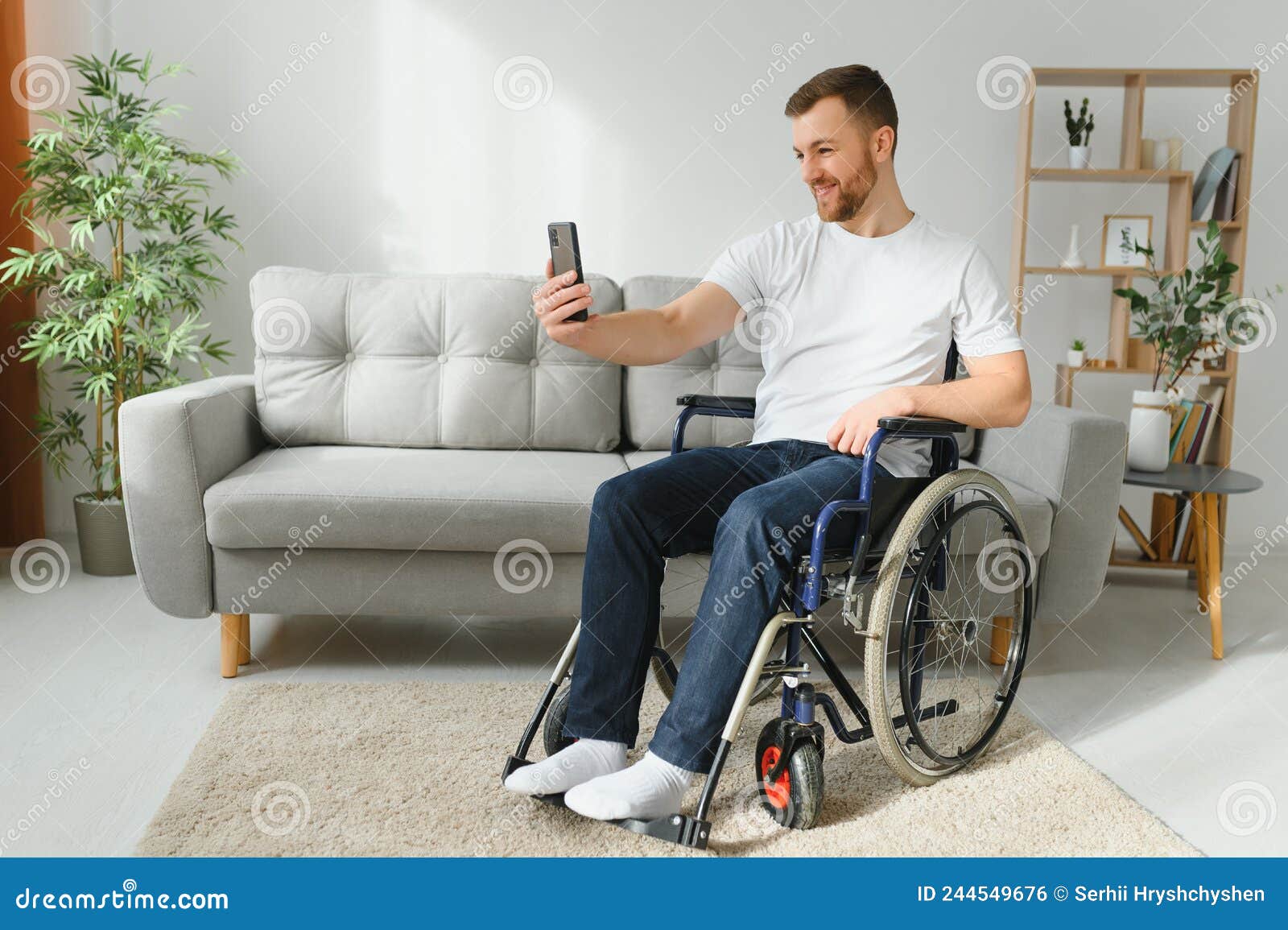 Disabled Man Using Modern Smartphone for Video Conversation while ...