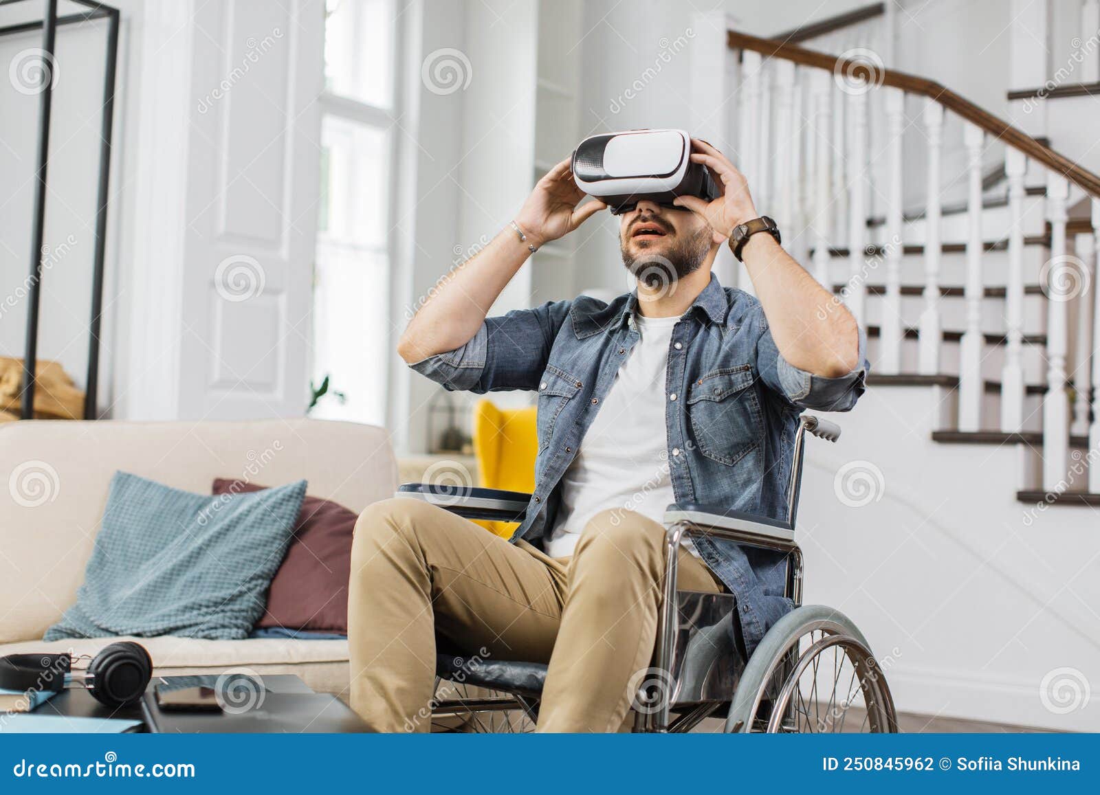 Disabled Man Watching Video Using VR Goggles at Home Stock Photo ...