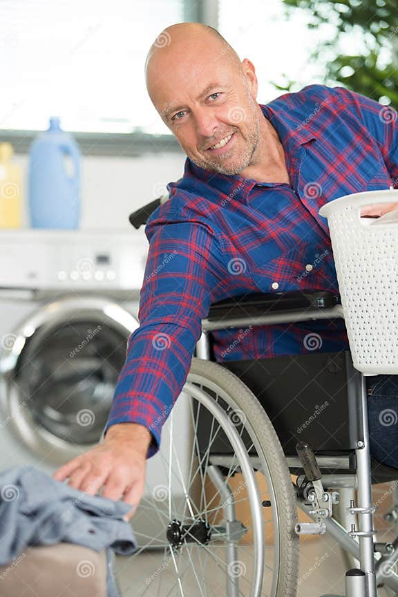 Disabled Man on Wheelchair Doing Laundry Stock Image - Image of ...