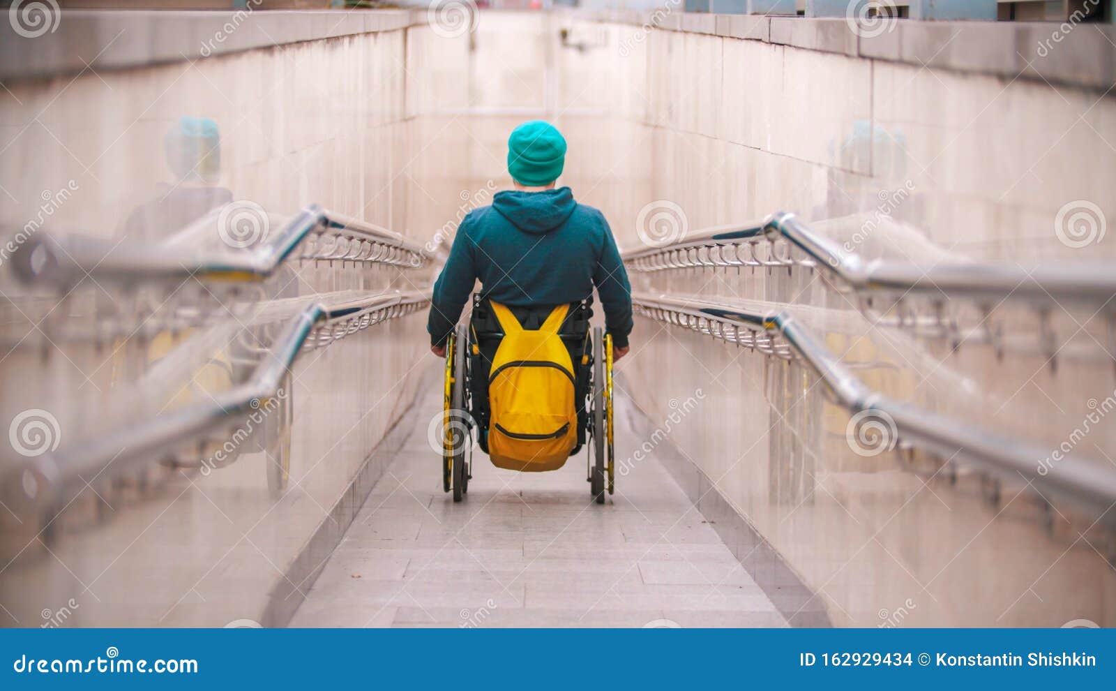 Disabled Man in Wheelchair Going Down the Long Ramp in the Subway Stock ...