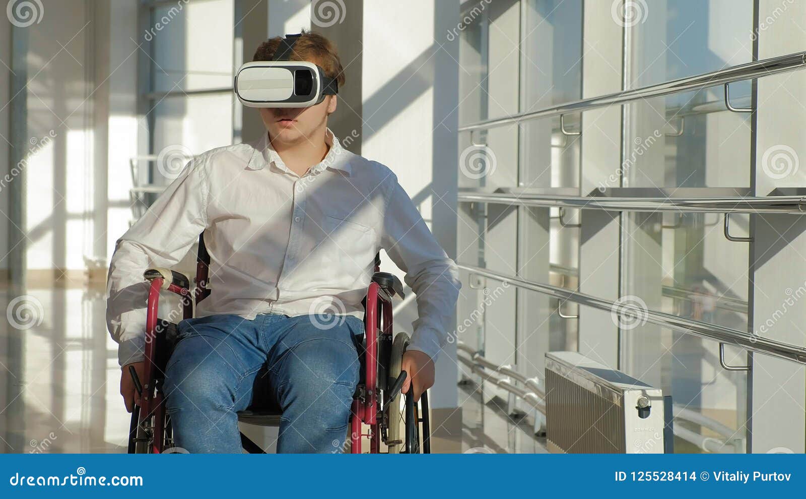 Disabled Man on a Wheelchair at a Window Uses a Helmet of Virtual ...